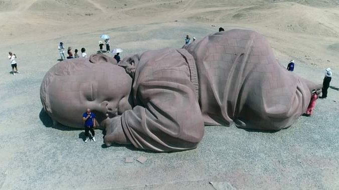 [วาสนา was] ทารก A giant sculpture depicting a slumbering infant rivets ...